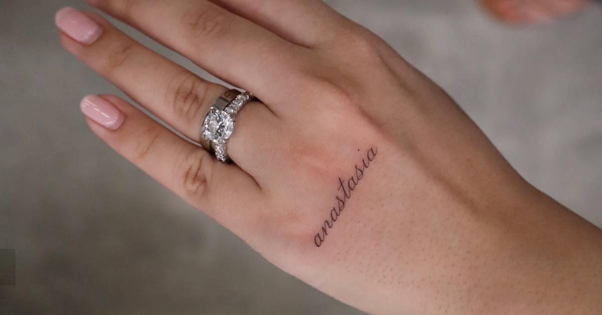 "Anastasia" lettering tattoo placed on the hand.
