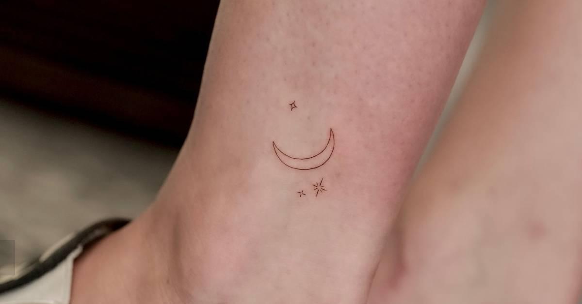 Fine line style moon and stars tattoo done on the