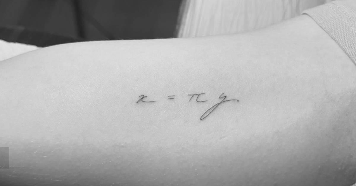 Equation tattoo located on the inner arm, minimalistic