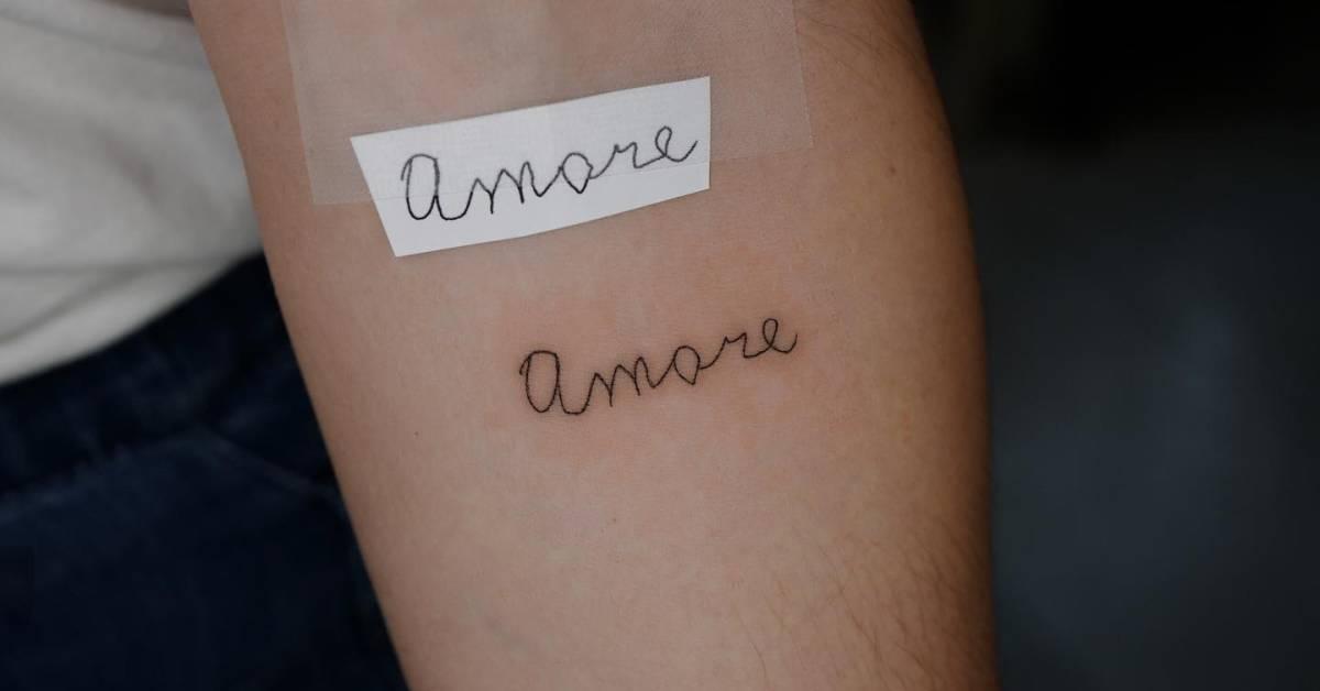 Lettering tattoo of the word "amore" located on the