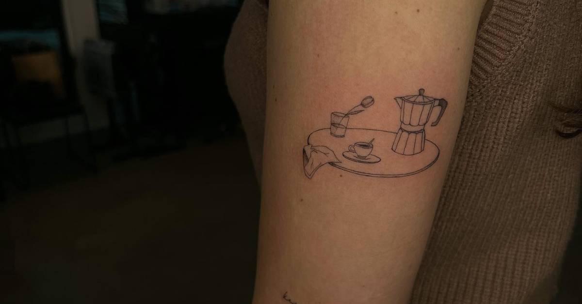 Coffee lover still life tattoo located on the tricep.