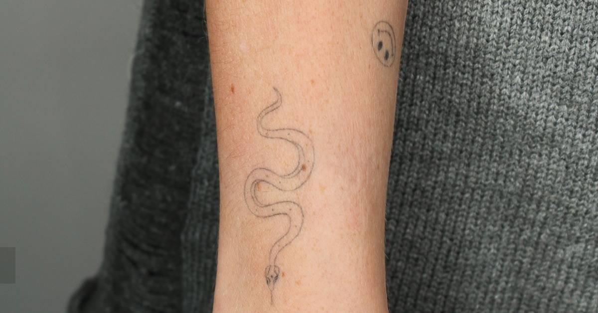 Snake tattoo in fine line style done on the wrist