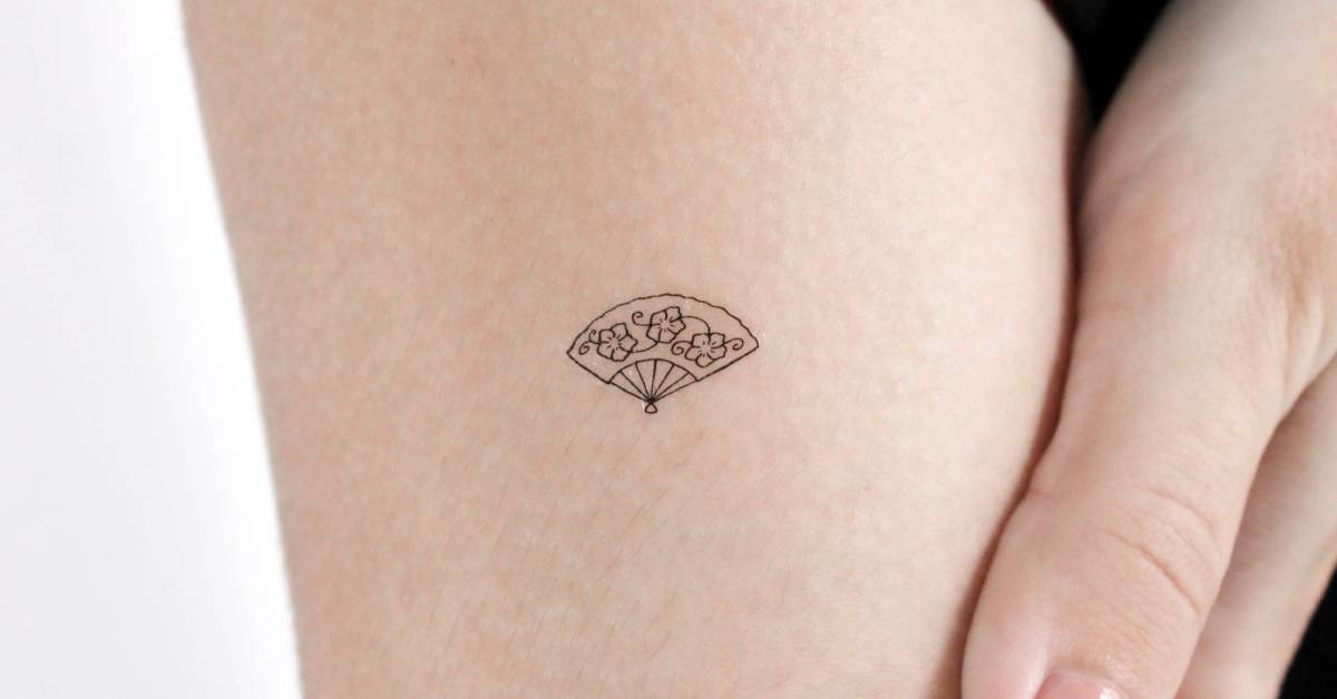 Fine line style hand fan temporary tattoo located on