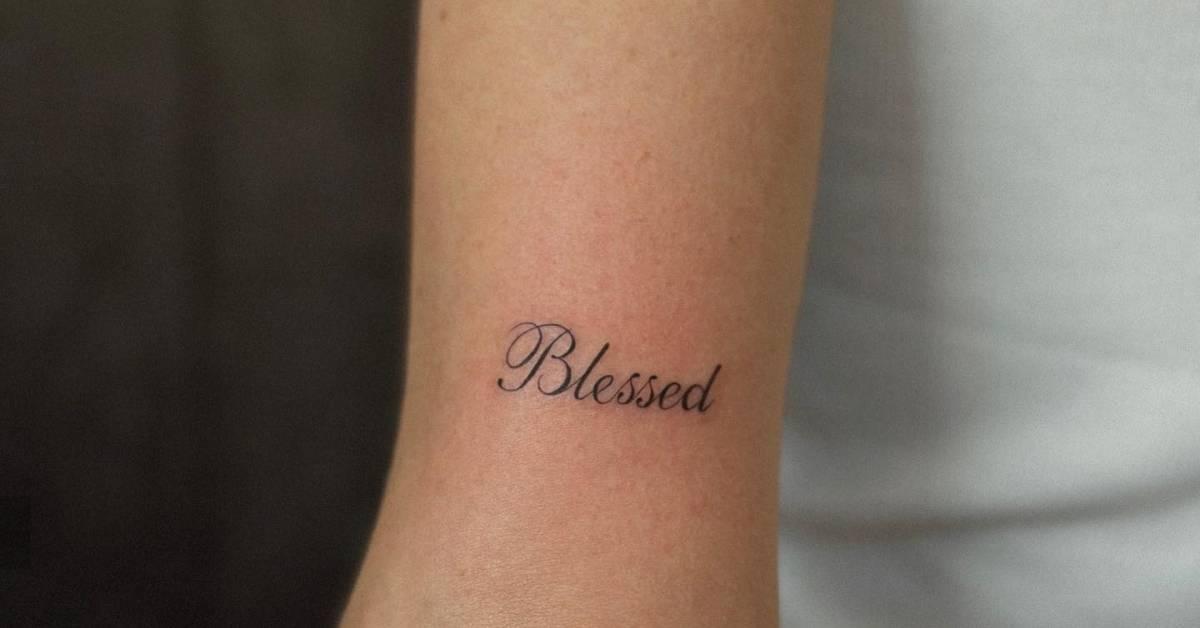 Lettering tattoo of the word "blessed" placed on the