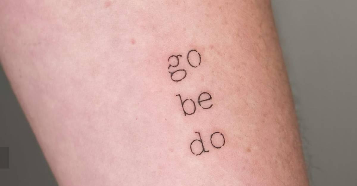 "Go, be and do" words tattooed on the inner forearm.