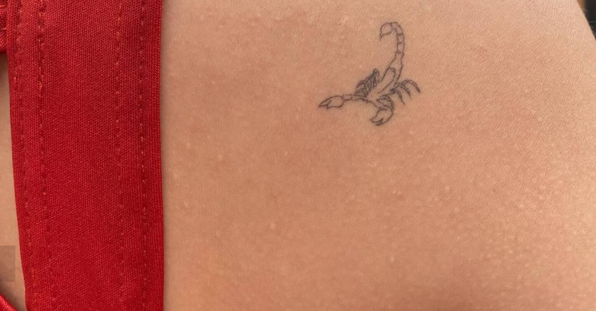 Healed fine line scorpion tattoo located on the