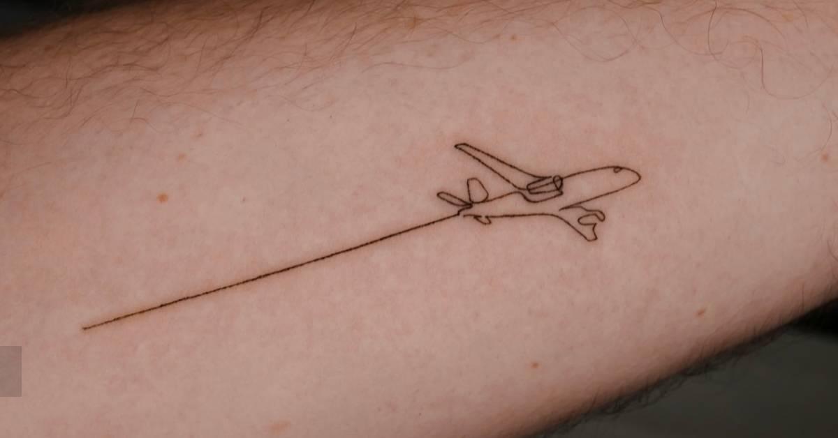 One line airplane tattoo located on the inner forearm.