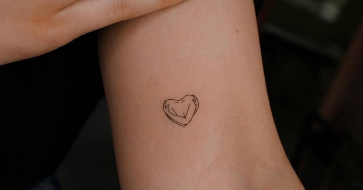 Self hug tattoo in fine line style located on the inner