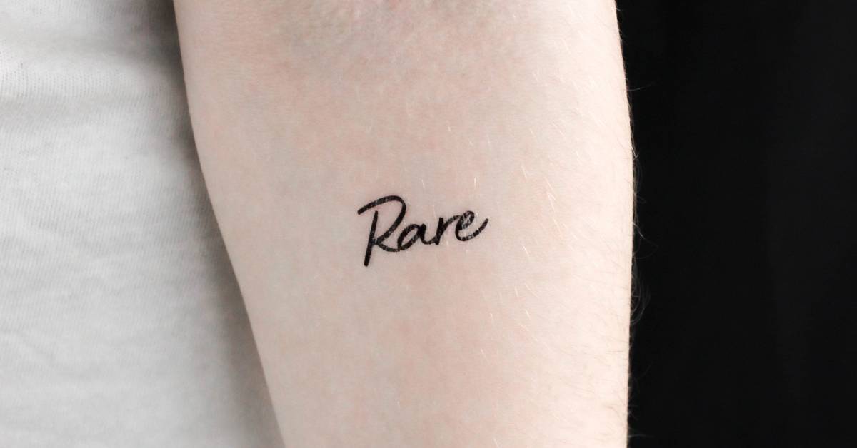Word "rare" temporary lettering tattoo located on the