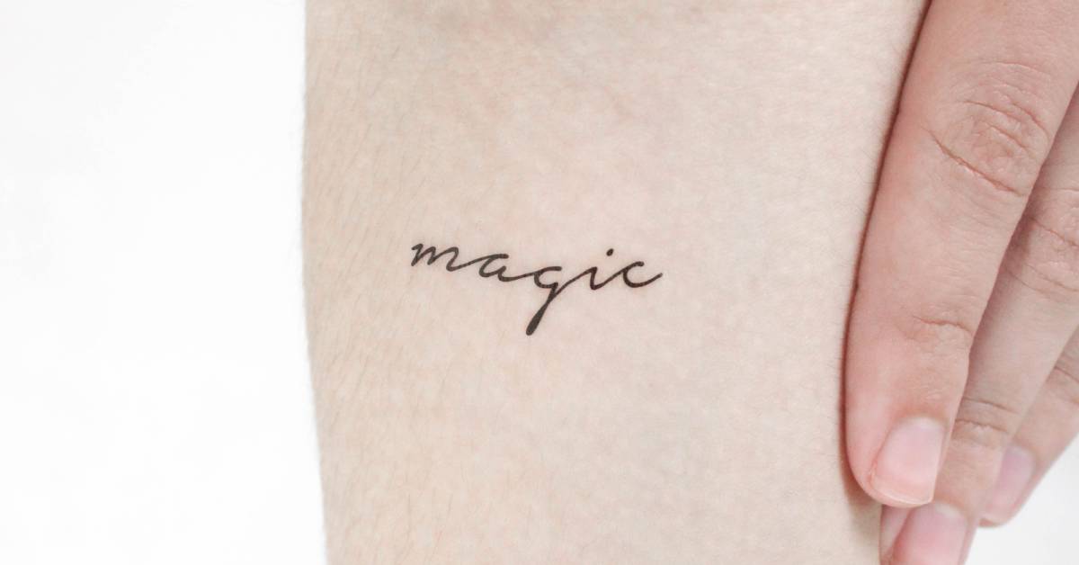 Handwritten word "magic" temporary tattoo done on the