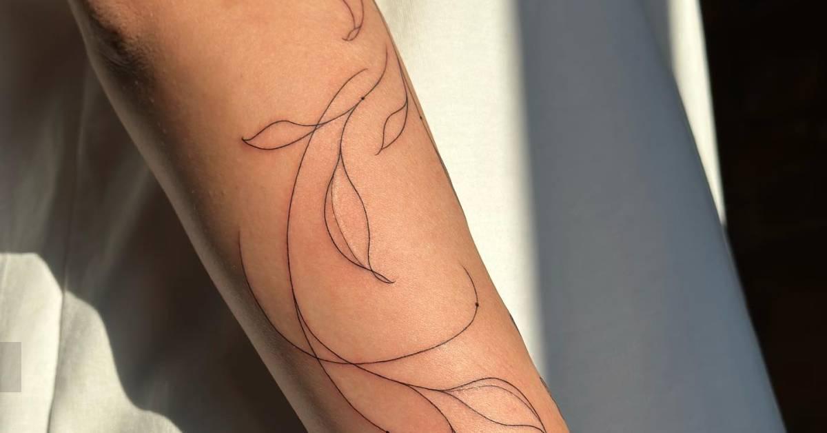 Fine line style leaves tattoo located on the forearm.
