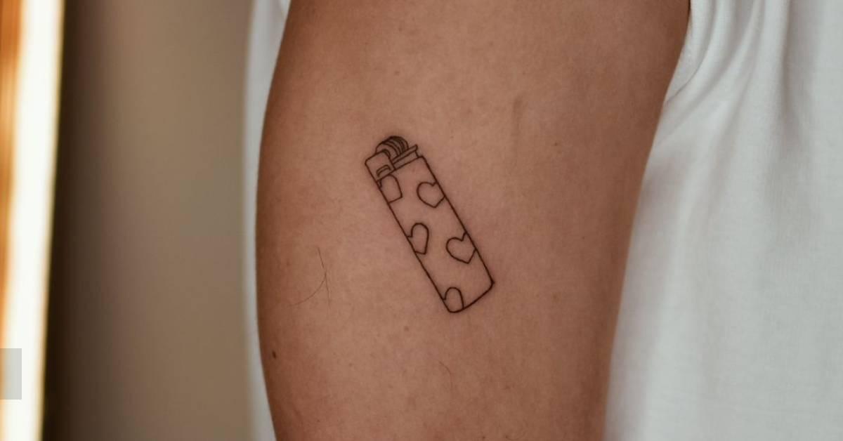 Hearty lighter tattoo located on the upper arm.