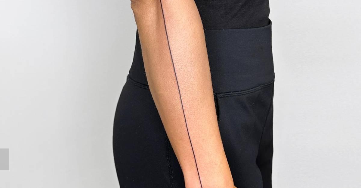 Minimalistic style lines tattooed on the arm.