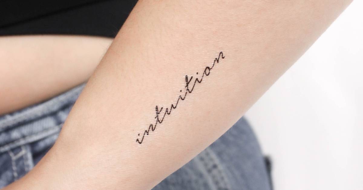 "Intuition" temporary lettering tattoo placed on the