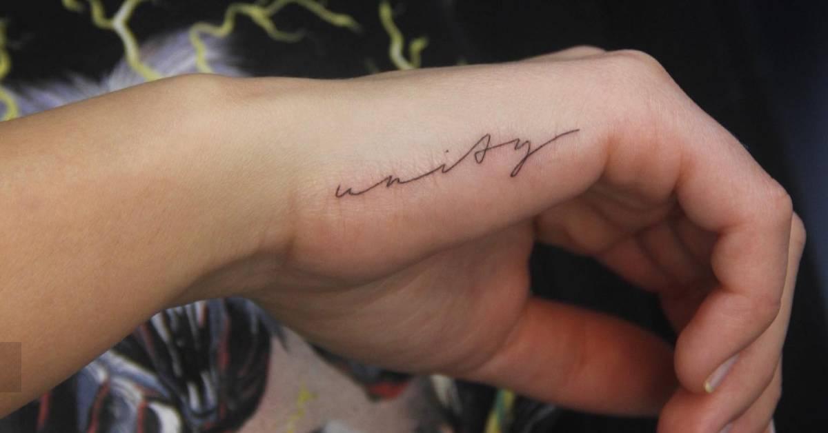 Lettering tattoo of the word "unity" located on the