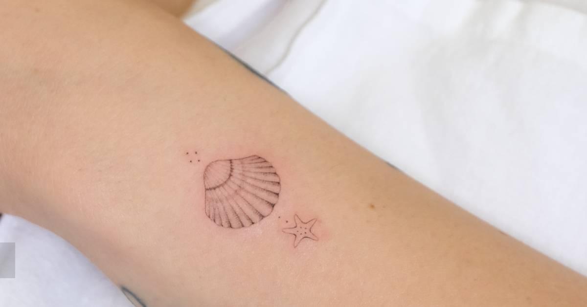 Single needle scallop shell and starfish tattoo located