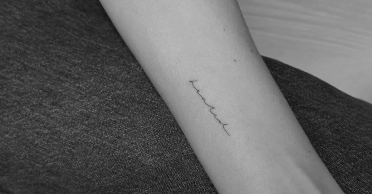 Lettering tattoo of the word "healed" placed on the