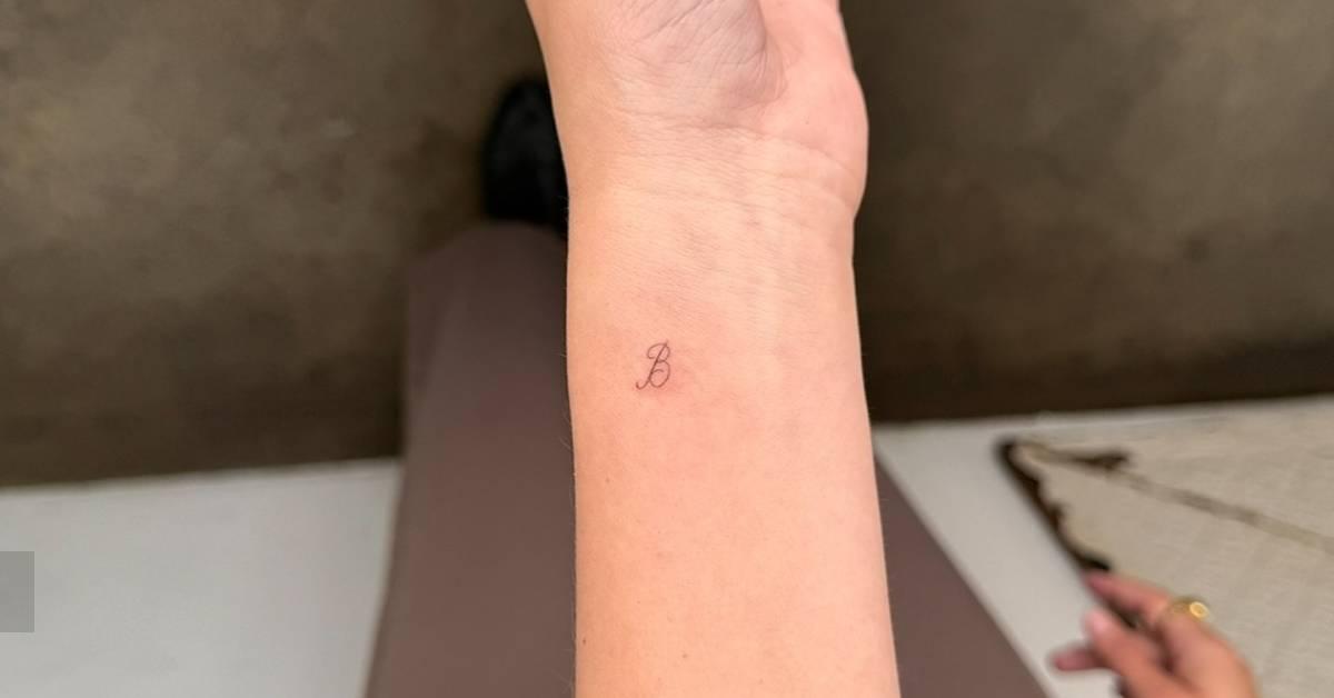 Minimalistic style letter "B" tattoo placed on the