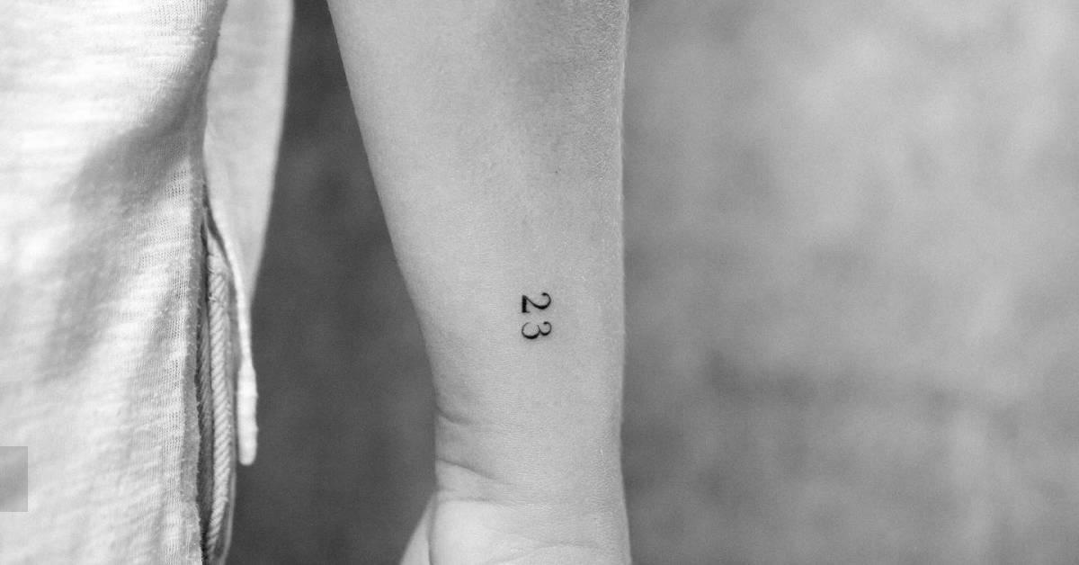 Tiny tattoo of the number "23" done on the wrist.