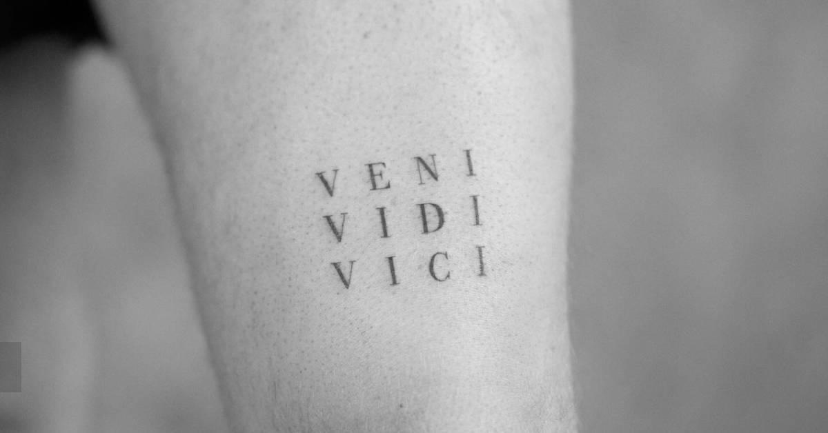 "Veni vidi vici" lettering tattoo located on the thigh.
