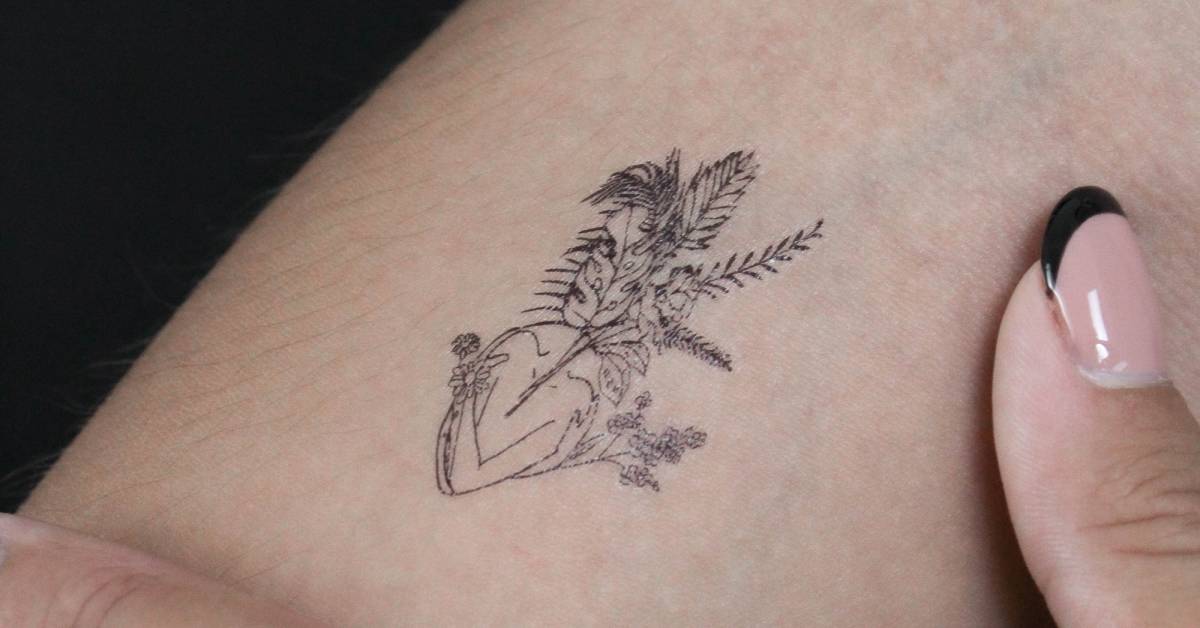 Flower head woman temporary tattoo located on the inner