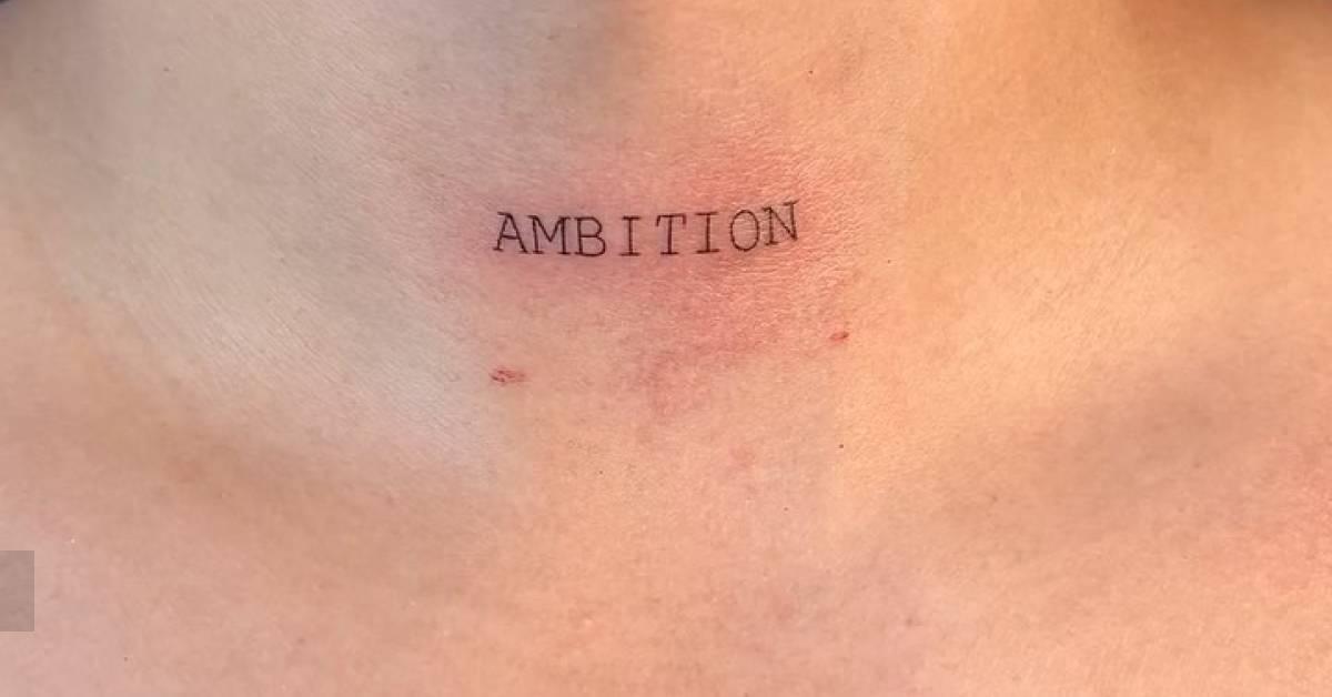 Lettering tattoo of the word "ambition" done on the
