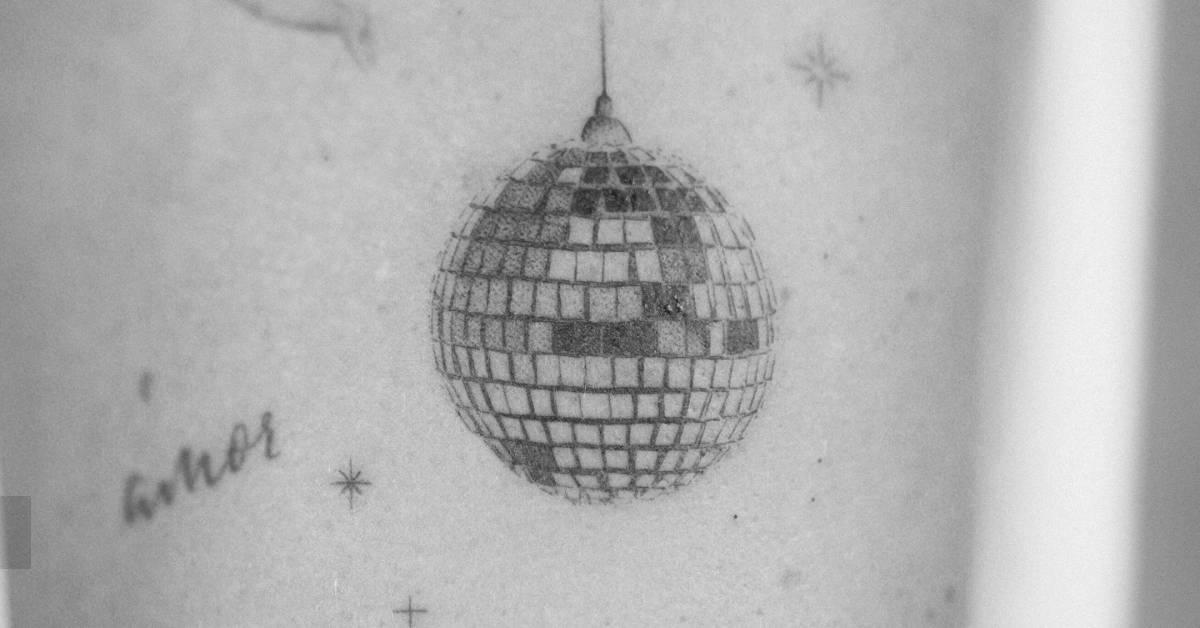Micro-realistic style disco ball tattoo located on the