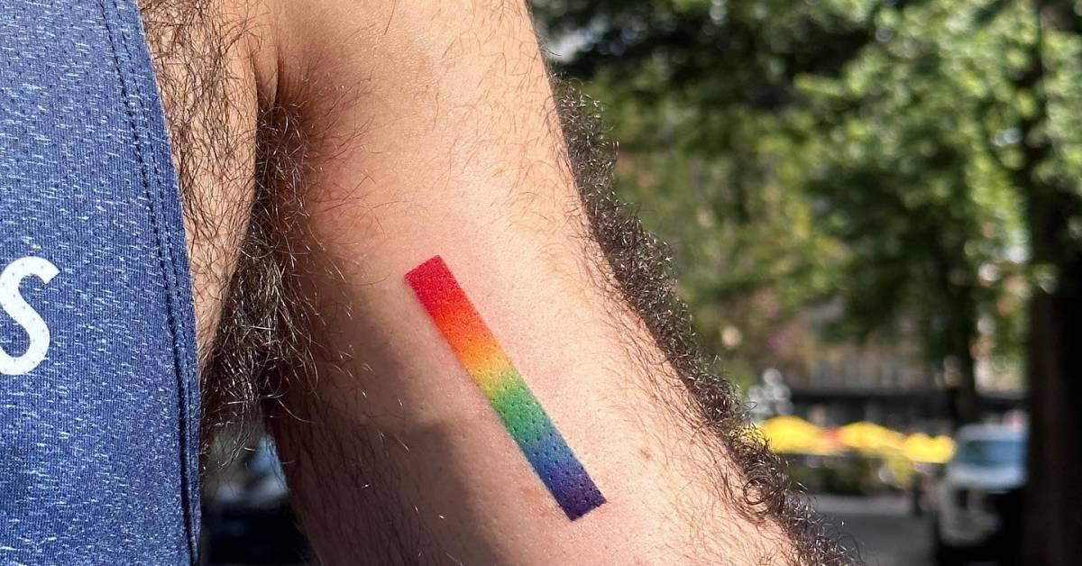 Visible spectrum tattoo located on the bicep,