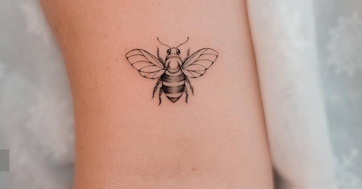 Illustrative style bee tattoo done on the bicep.