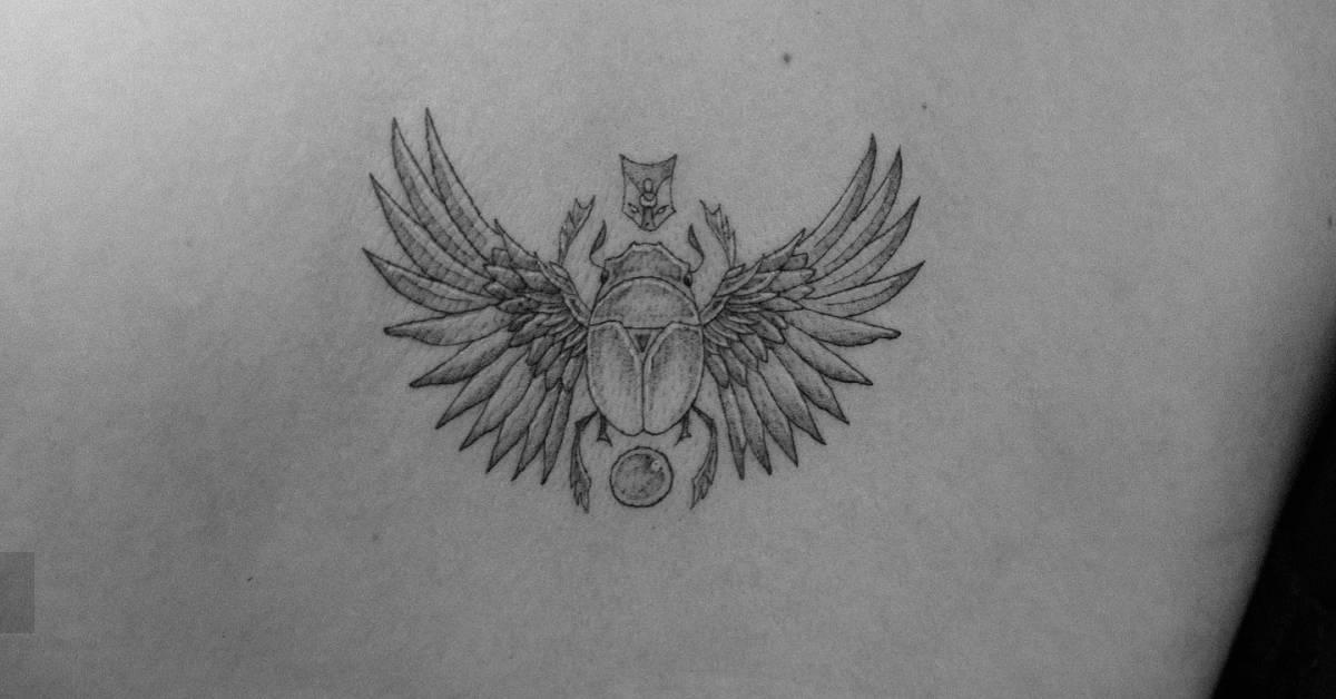 Illustrative style scarab tattoo located on the upper