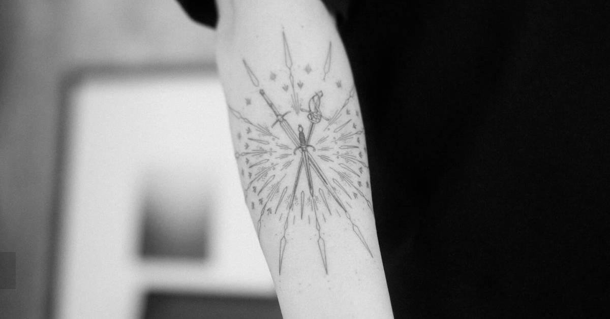 Fine line style ornamental swords tattoo located on the