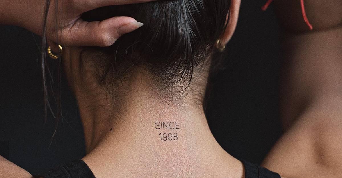 "Since 1998" lettering tattoo located on the back of