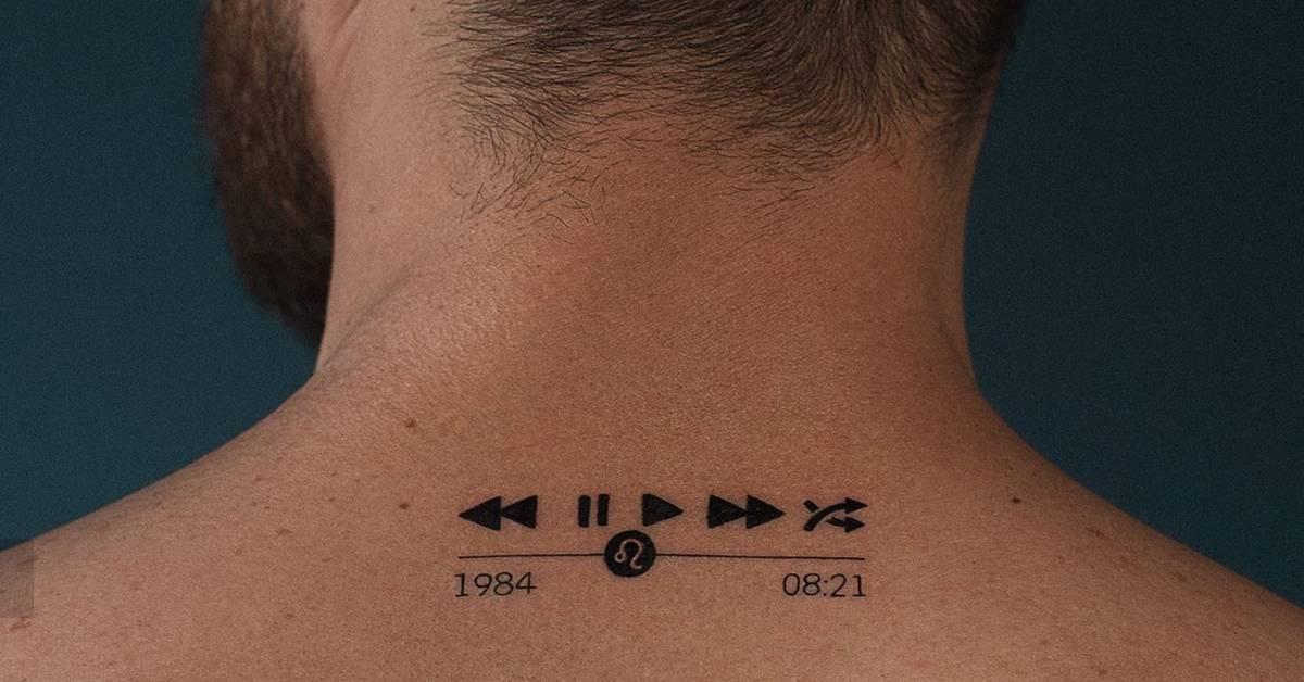 Music media controls tattoo located on the upper back.