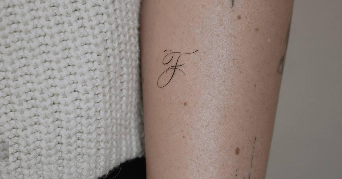 Letter "F" tattoo located on the forearm.