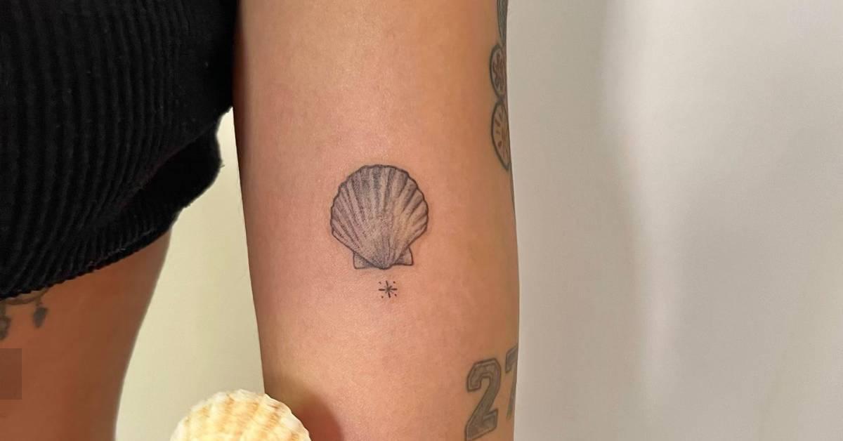 Illustrative style scallop shell tattoo located on the