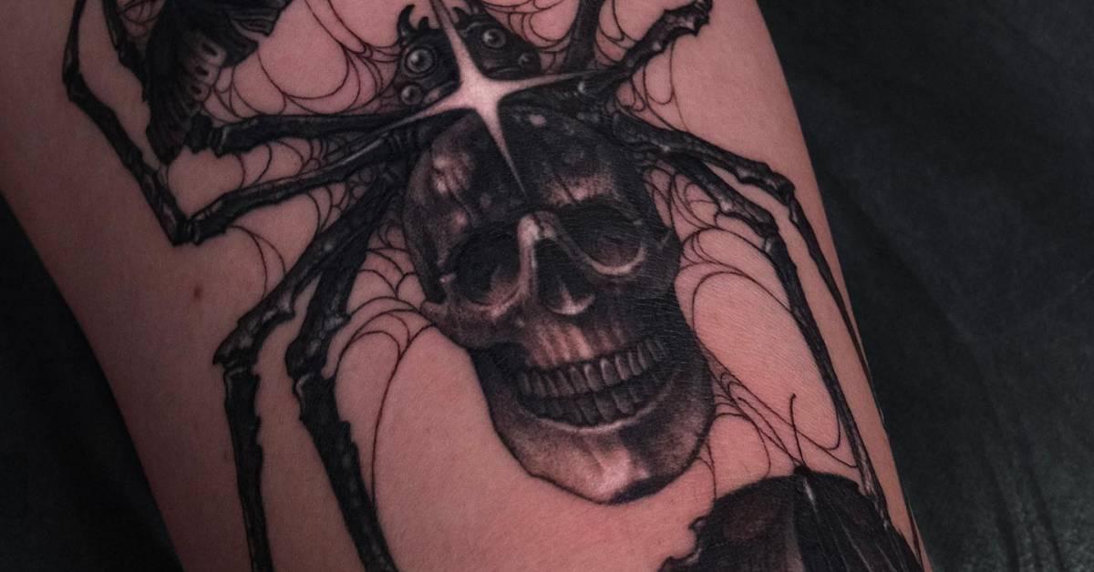 Skull spider tattoo placed on the thigh, illustrative