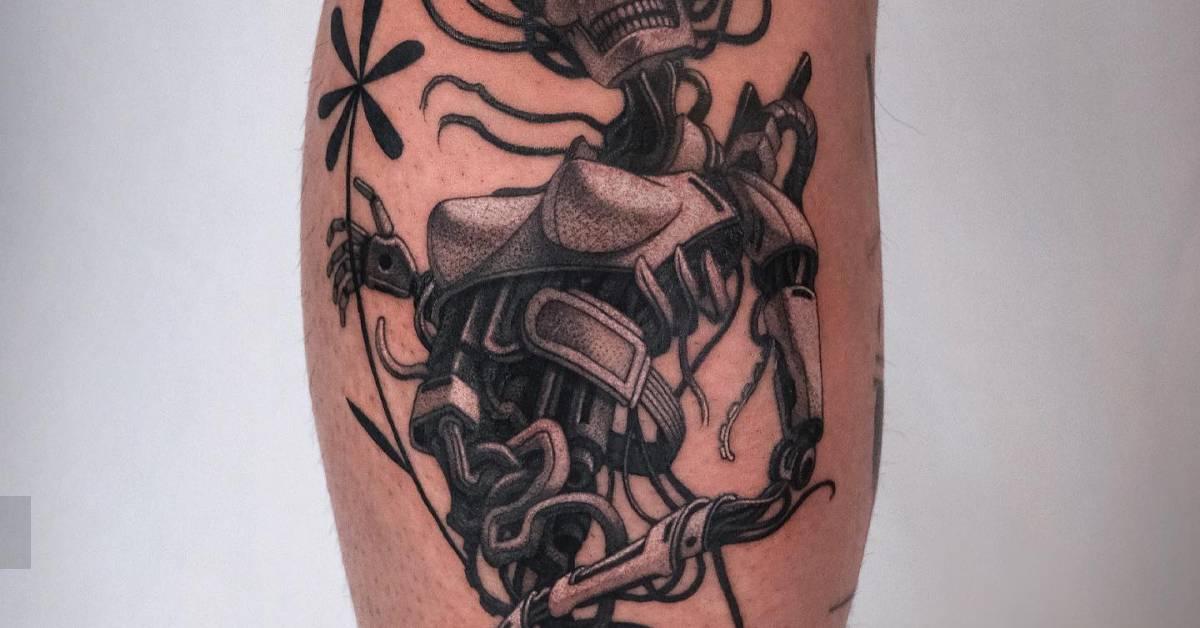 Comic style humanoid robot tattoo placed on the calf.