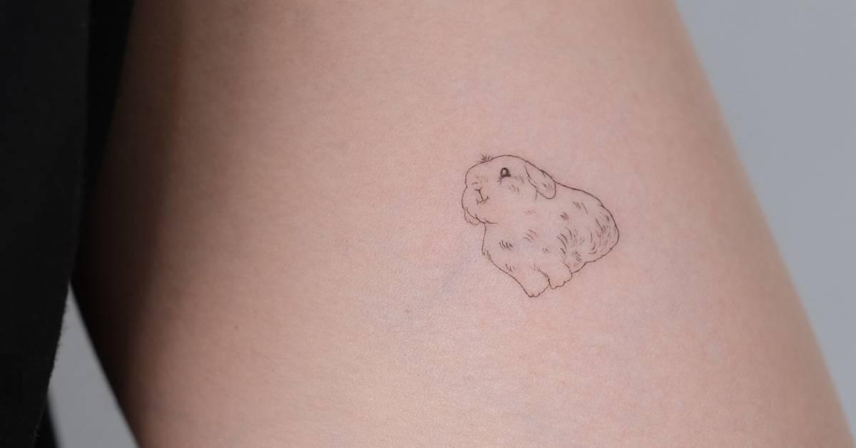 Fine line style rabbit tattoo located on the inner arm.