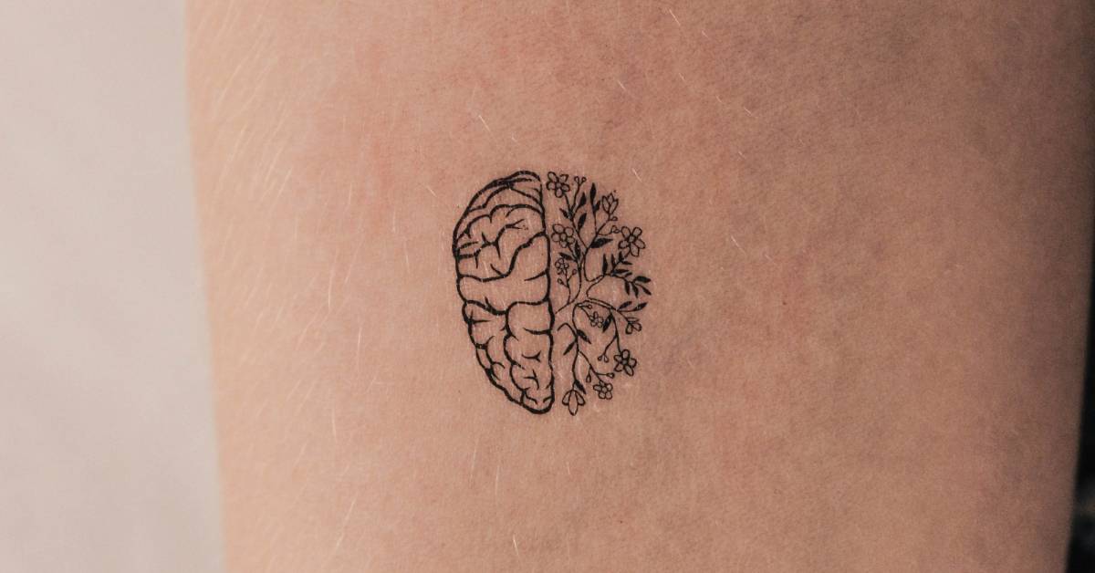 Fine line style flower brain temporary tattoo located