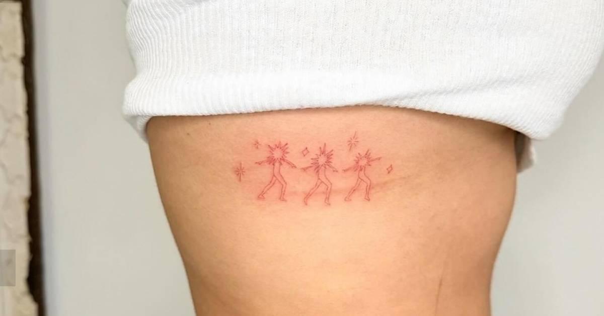 Fine line style dancers in red ink tattooed on the rib.