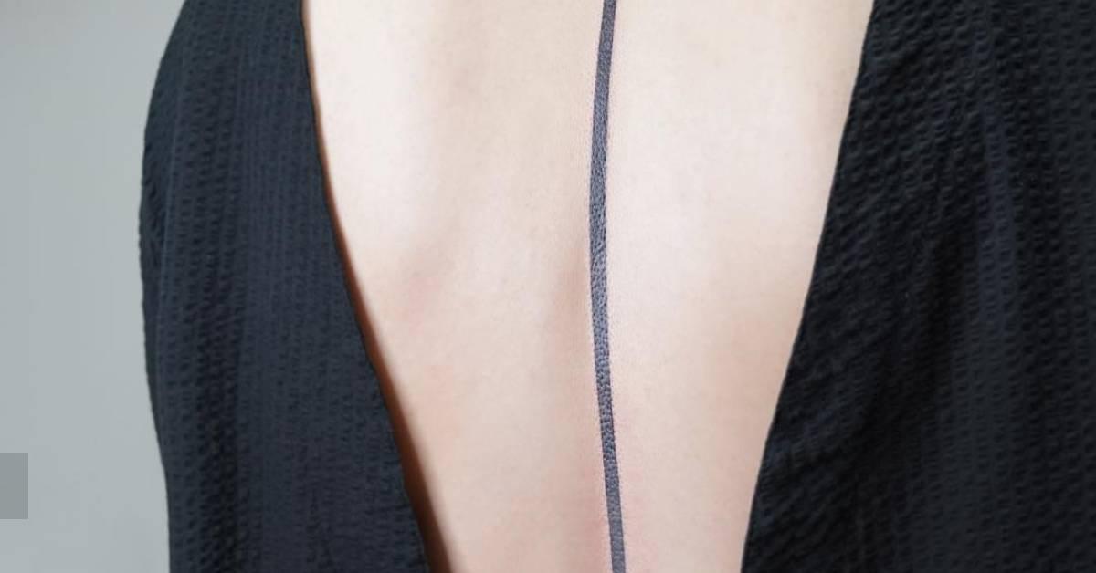 Minimalistic line tattoo located on the spine.