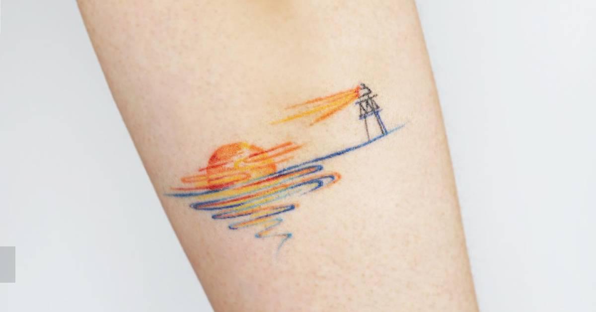 Watercolor style sea sunset tattoo located on the inner