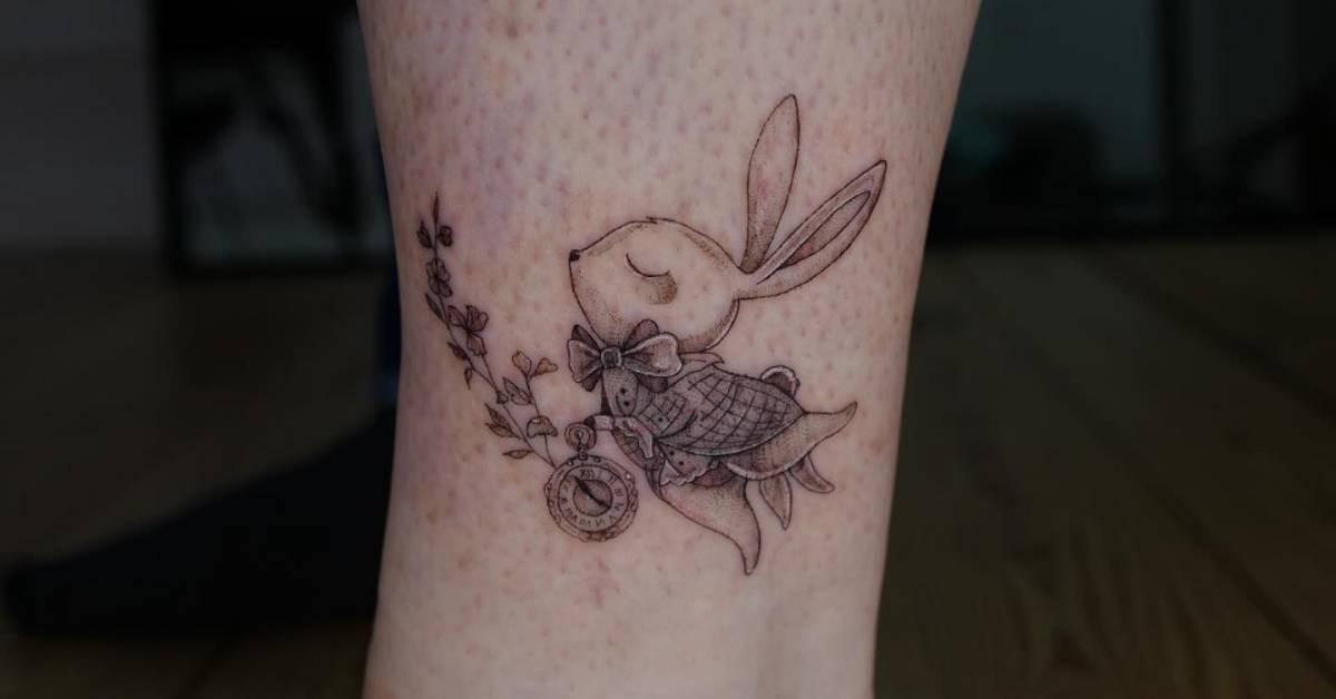 White Rabbit tattoo located on the ankle.