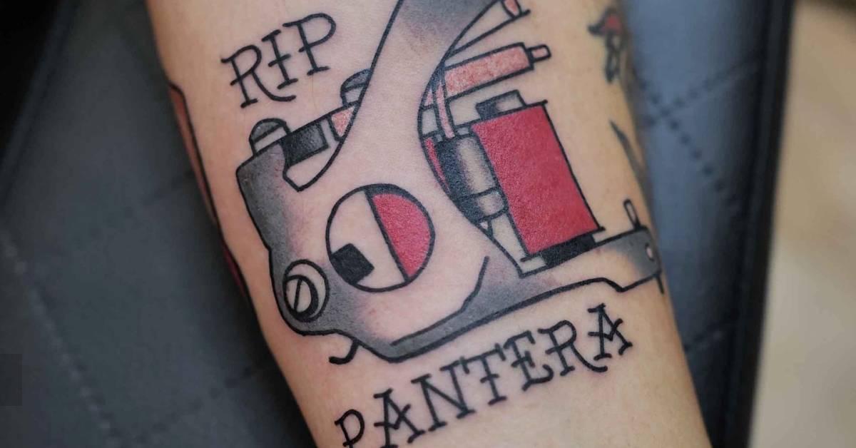 Tattoo machine in traditional style tattooed on the