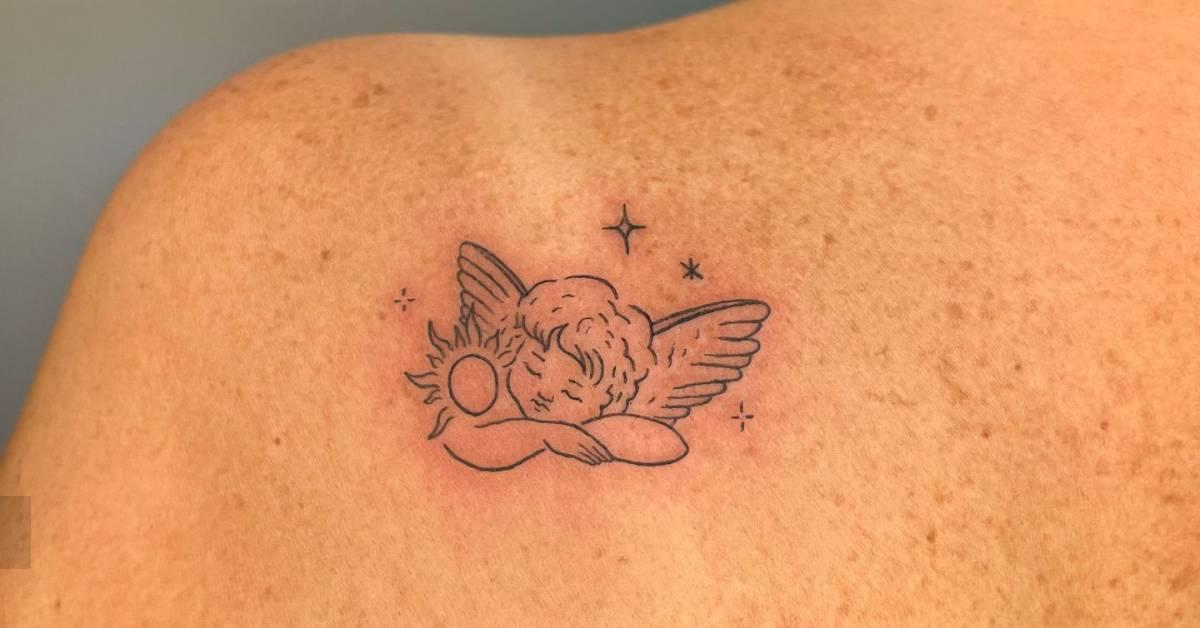 Fine line style cherub tattoo placed on the shoulder