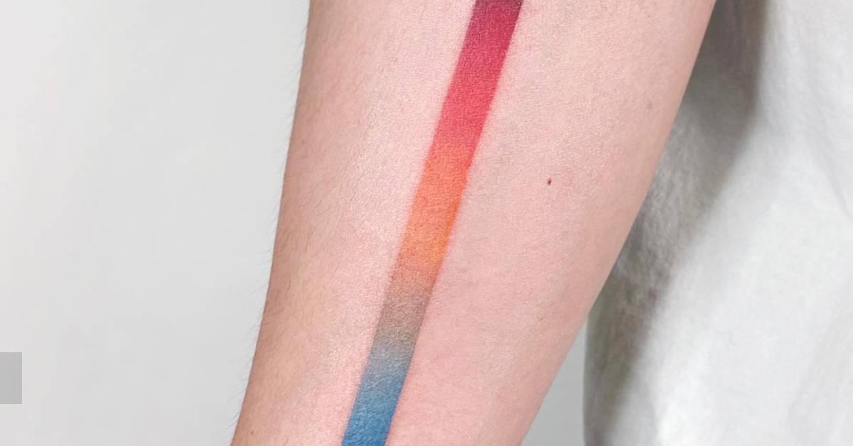 Spectrum line tattoo in watercolor style located on the