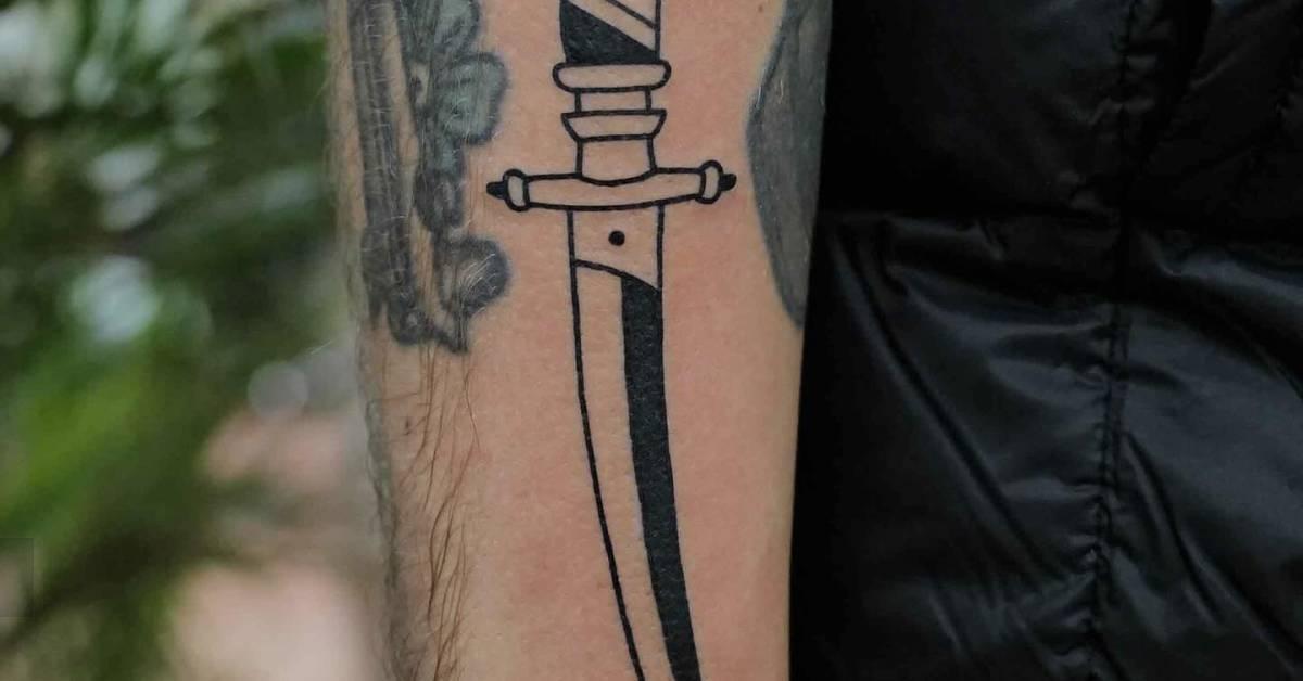 Dagger tattoo in traditional style done on the forearm.