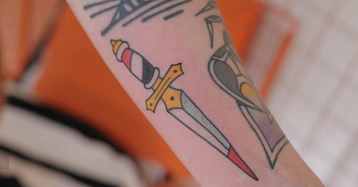 Dagger tattoo located on the inner forearm, traditional