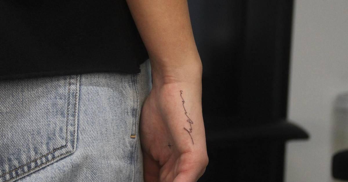 Lettering tattoo of the word "unity" located on the