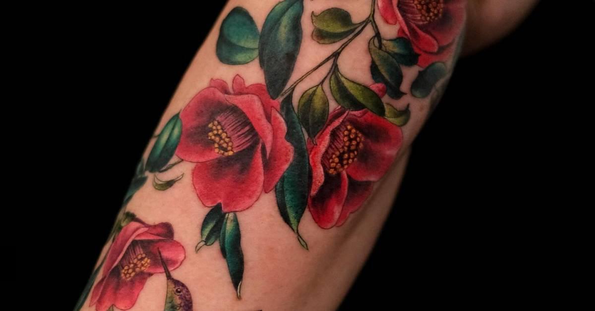 Camellias and hummingbird tattoo located on the